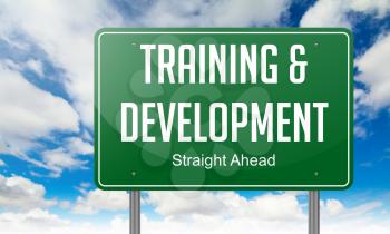 Highway Signpost with Training and Development wording on Sky ...